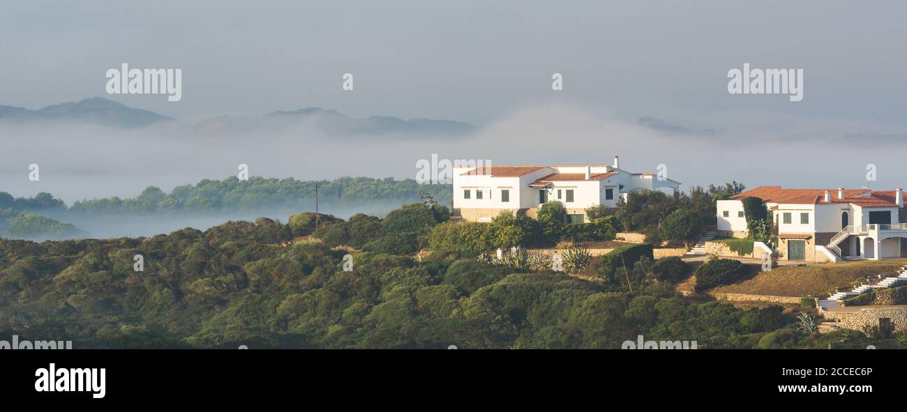 Traditional Spanish architecture with summer villas on hills. Misty ...