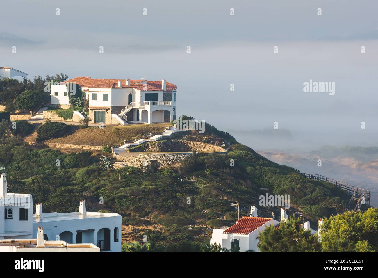 Traditional Spanish architecture with summer villas on hills. Misty ...