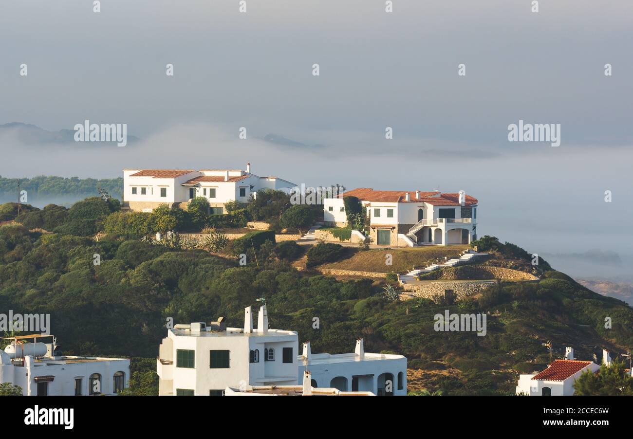 Traditional Spanish architecture with summer villas on hills. Misty ...