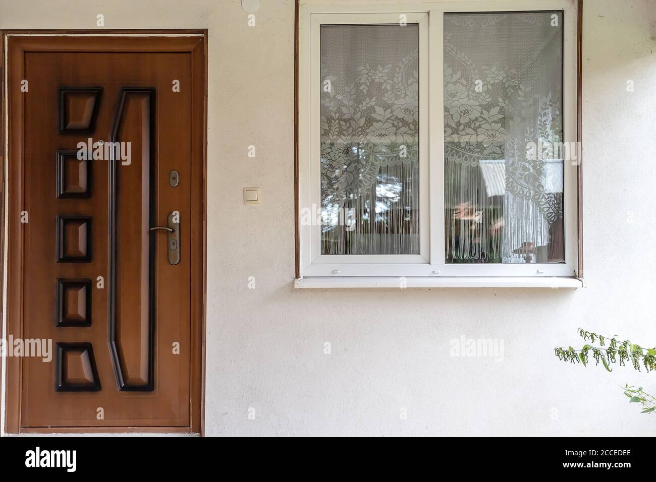 front door next to the window, detail of the exterior of a small house ...