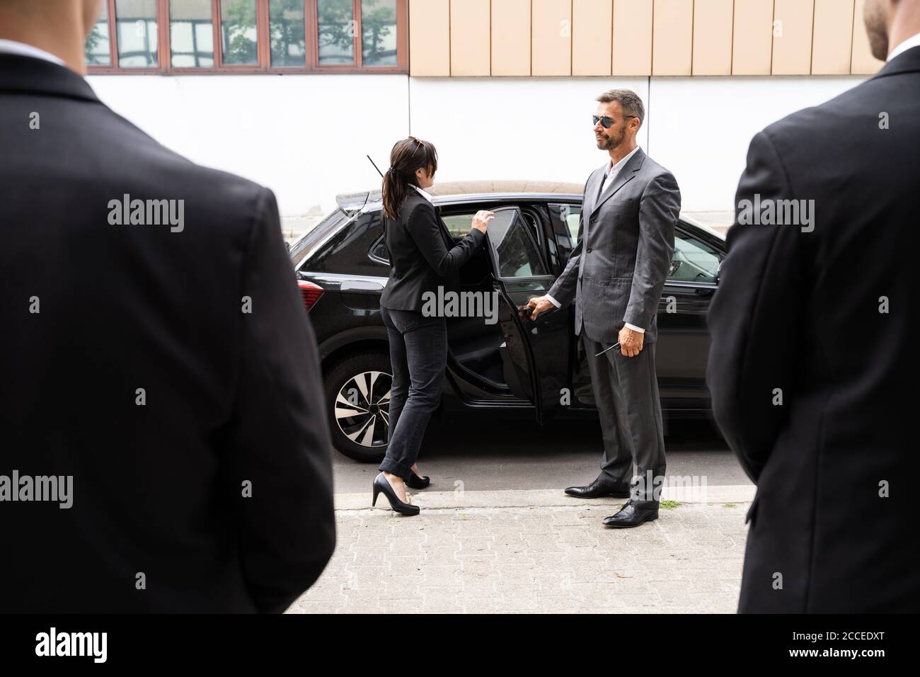 Bodyguards Protecting Businesswoman Opening Car Vehicle Door Stock ...