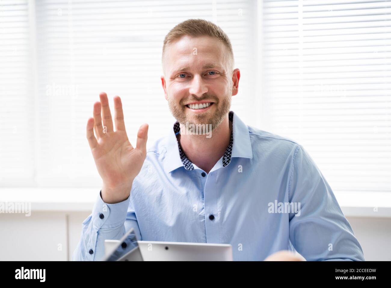 Man Portrait Waving Hello In Video Conference Stock Photo - Alamy