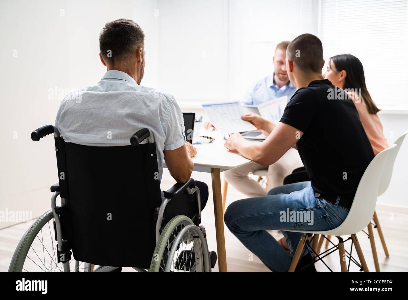 Disabled People In Wheelchair At Workplace Business Meeting Stock Photo ...