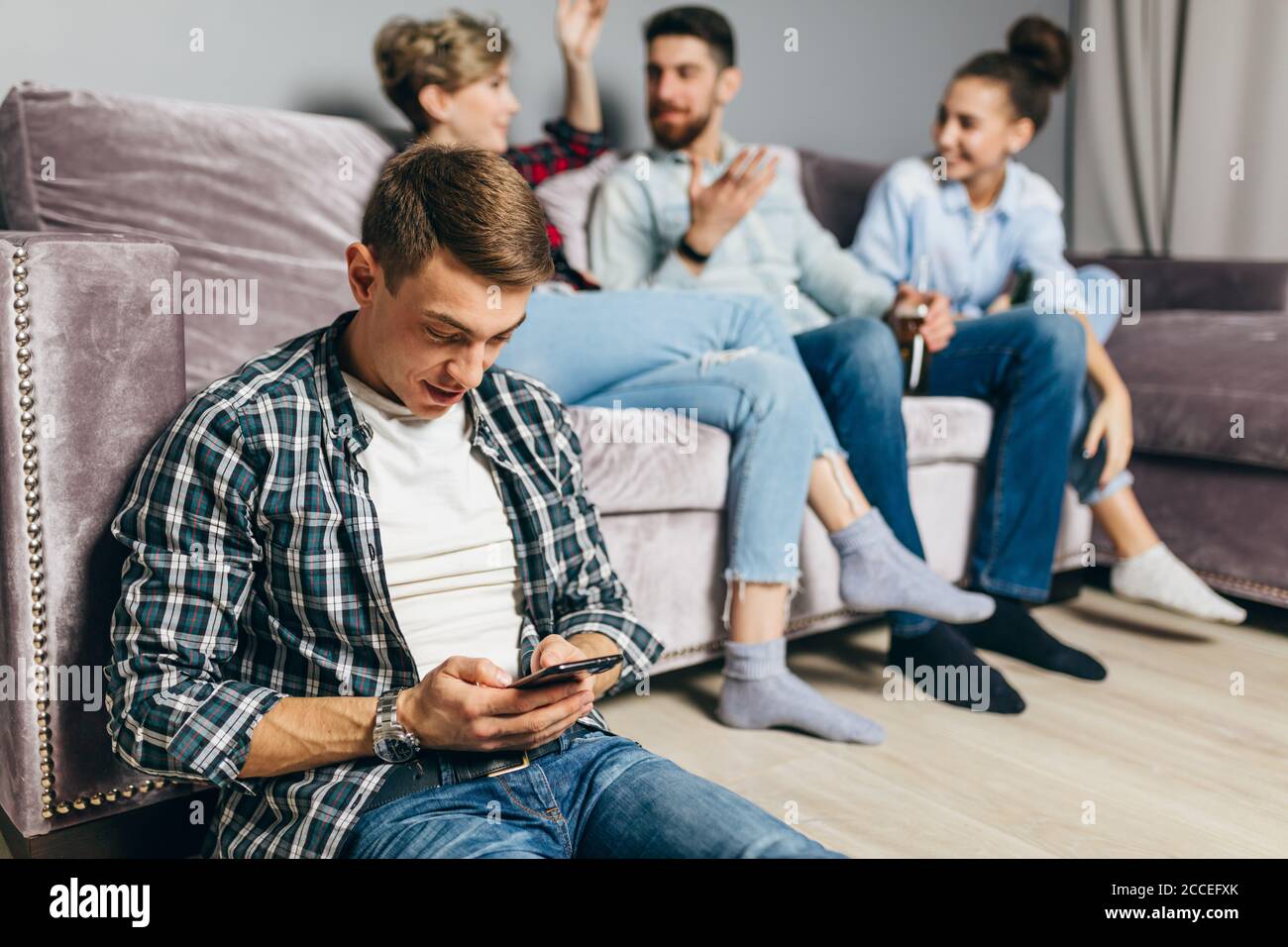 young awesome guy is sitting on the phoneand making a phone call while ...