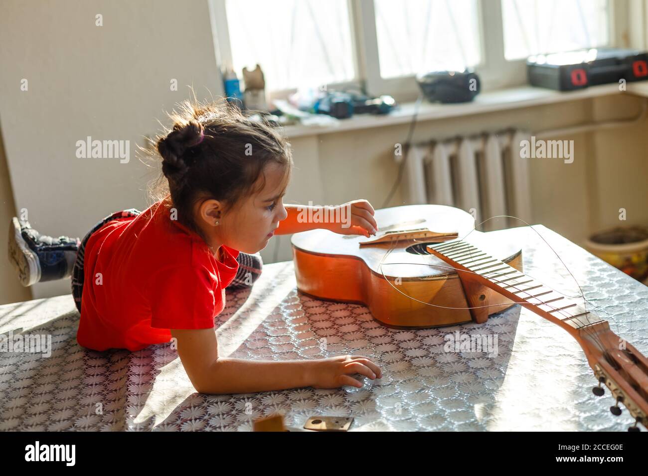 Closeup strings of a broken guitar. Broken music instrument Stock Photo ...