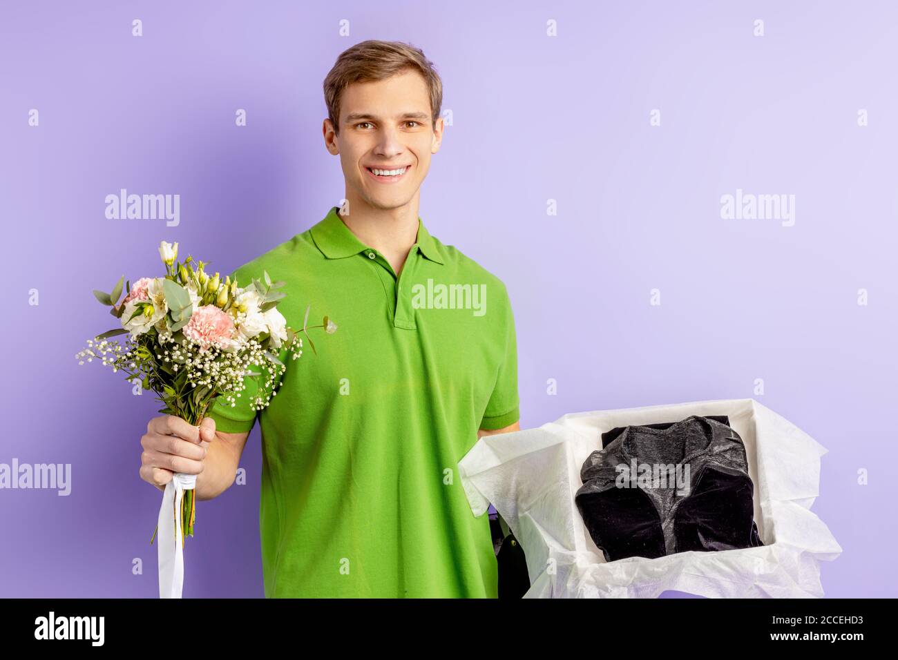 fast delivery by young vigorous man holding flowers for customer ...