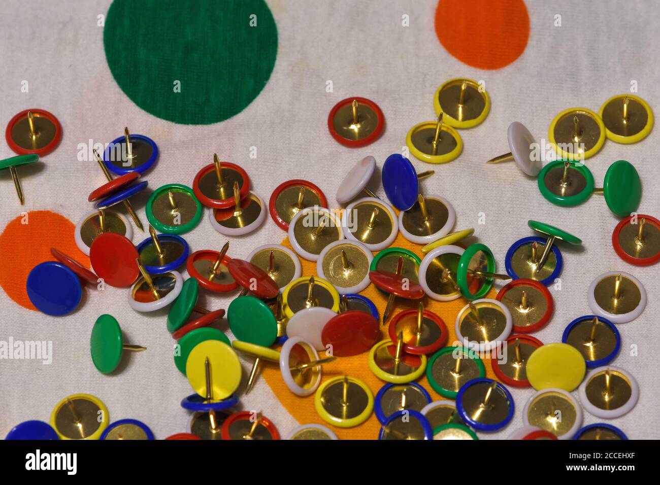 Scattered thumbtacks on a colored plane, horizontal image Stock Photo ...