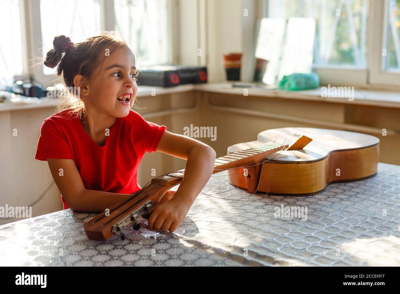 Closeup strings of a broken guitar. Broken music instrument Stock Photo ...
