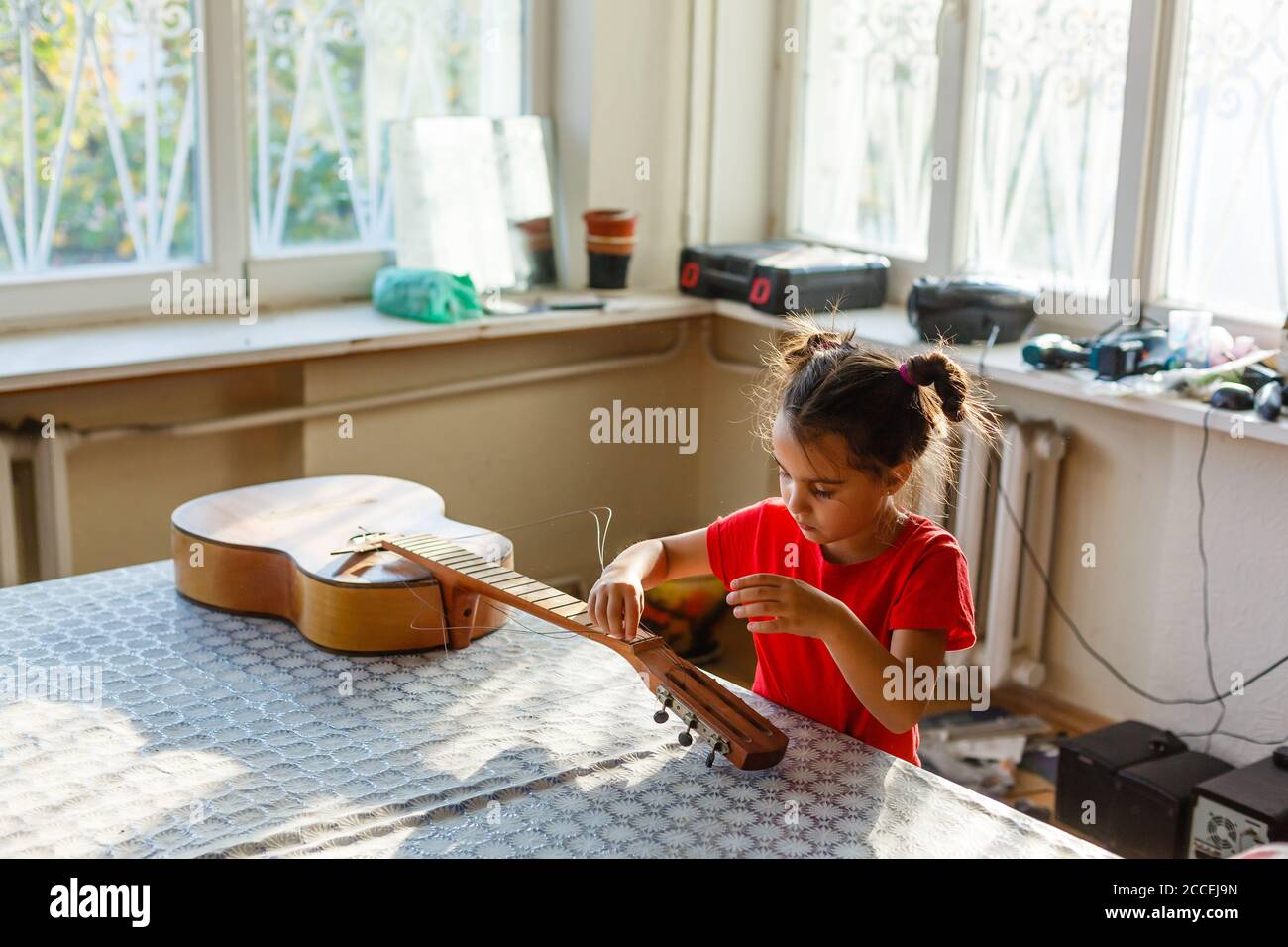 Closeup strings of a broken guitar. Broken music instrument Stock Photo ...