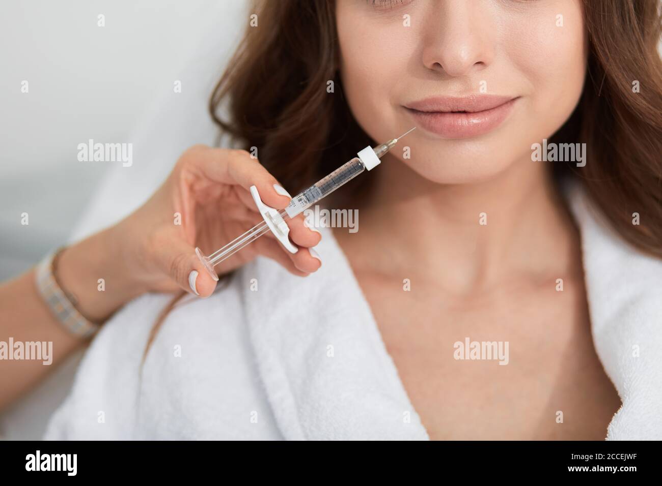Plastic surgery concept. beautician holding syringe near female face ...