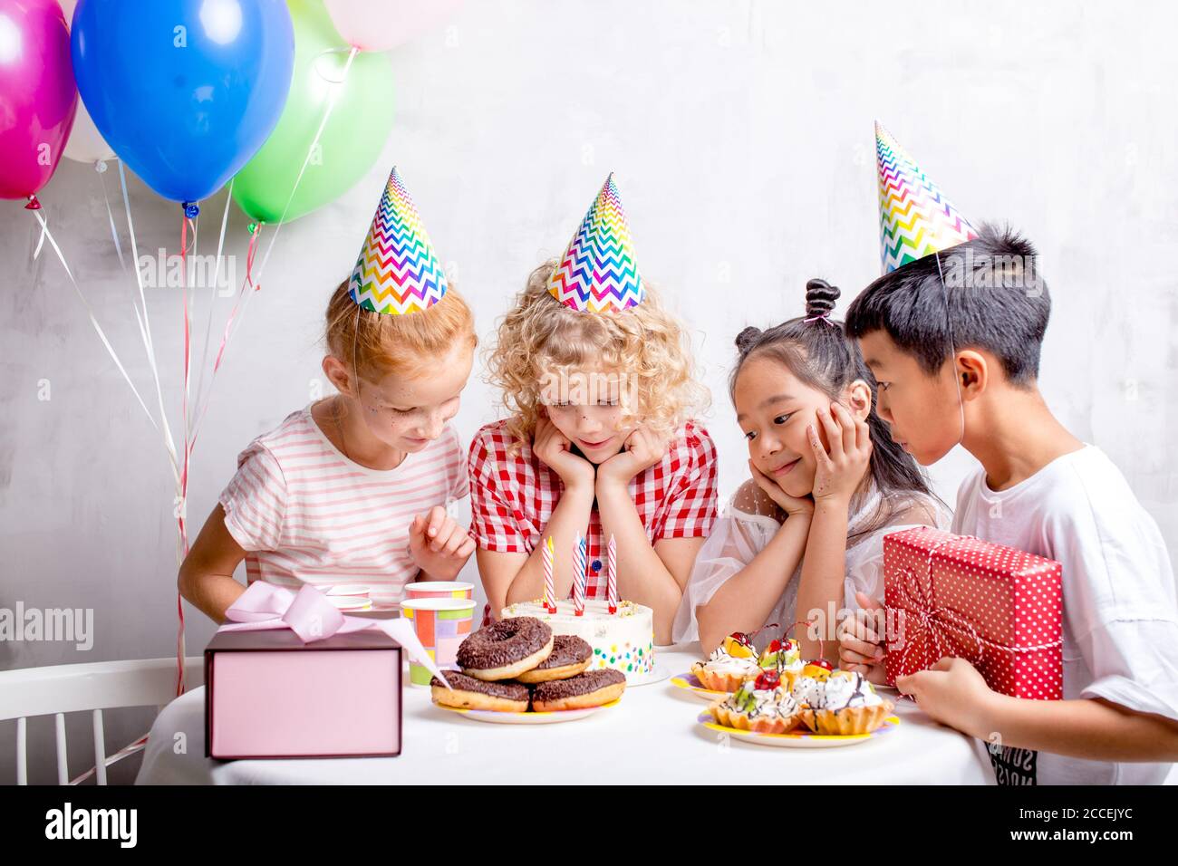 happy adorable kids are going to eat cake. cheerful children are ready ...