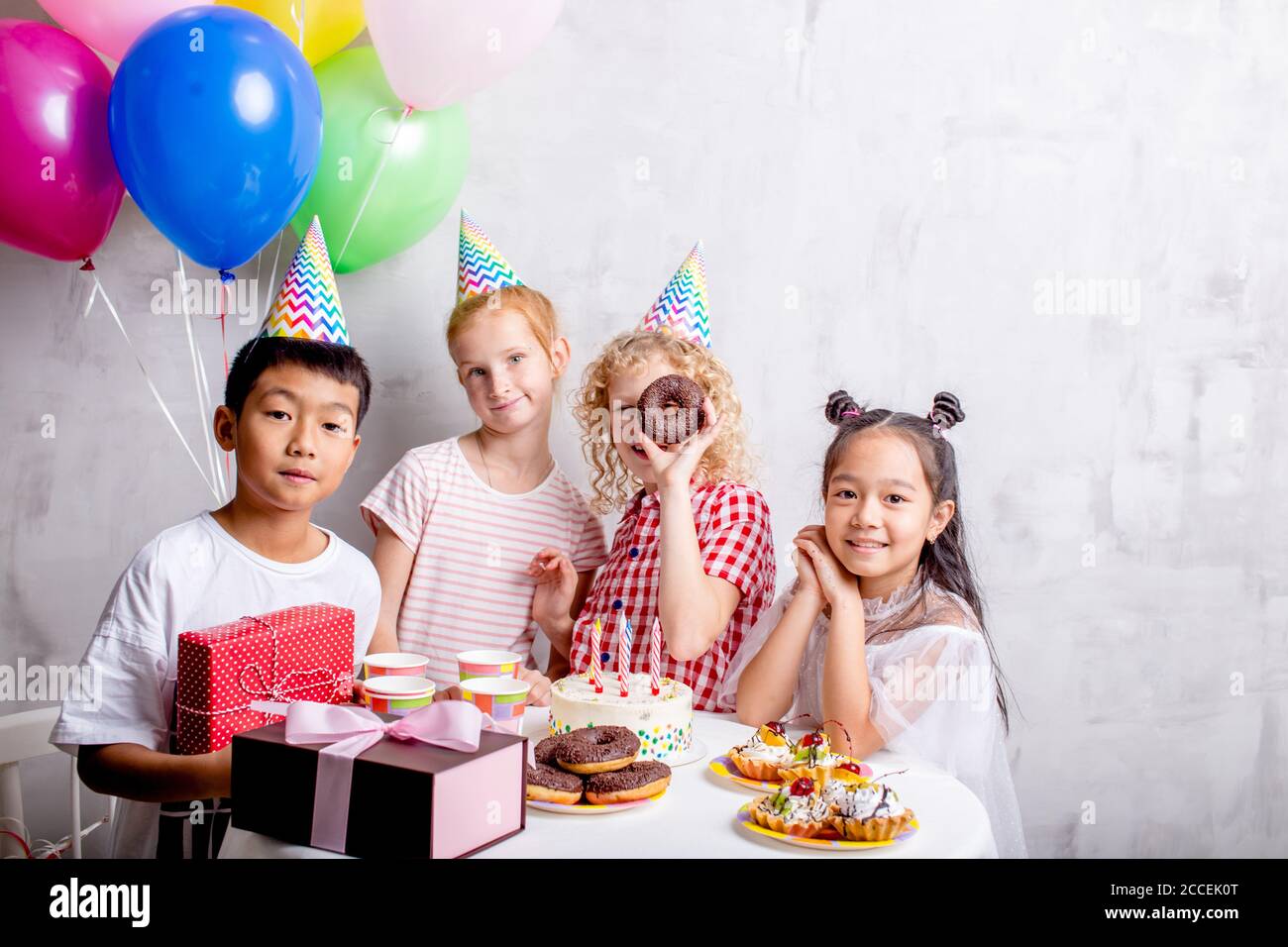 joyful group of happy children standing near the table. closeup photo ...