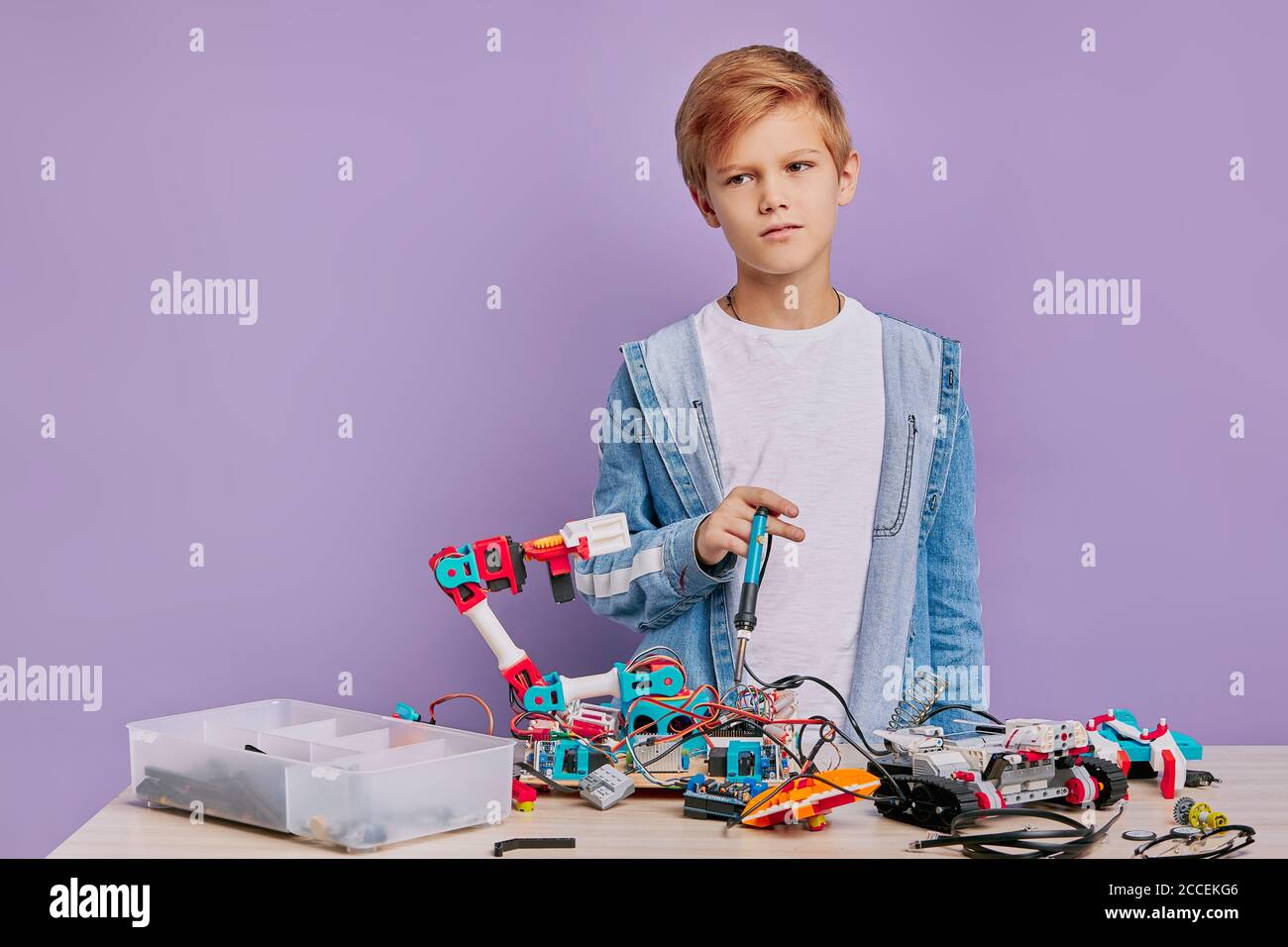 portrait of adorable enthusiastic boy keen on robotics, robot ...