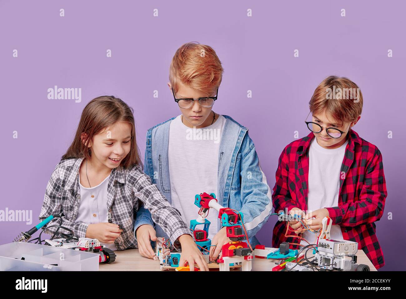 future engineers and designers. caucasian kids try to connect wires and ...