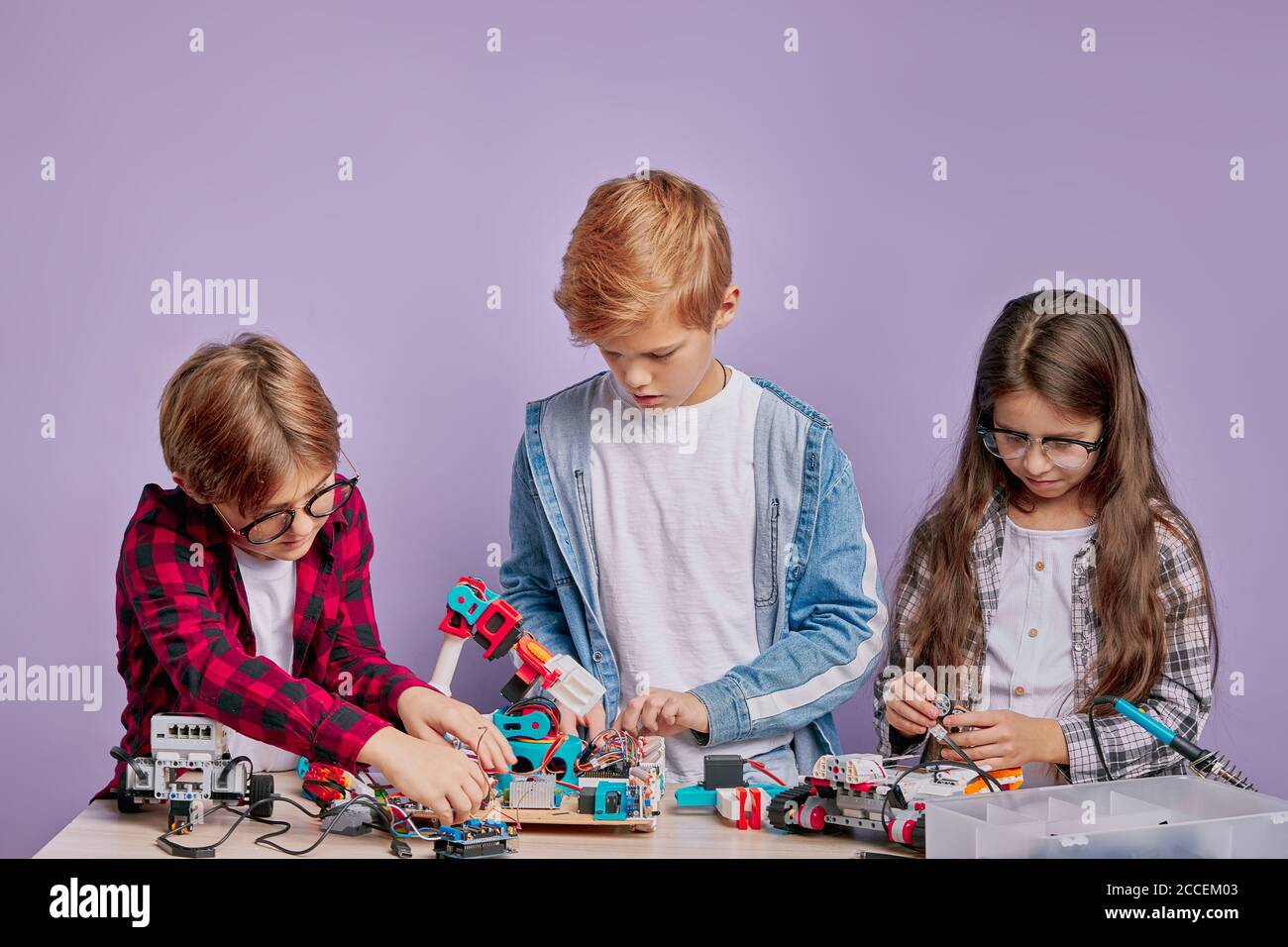 future engineers and designers. caucasian kids try to connect wires and ...