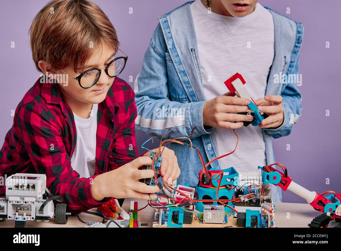 future engineers and designers. caucasian kids try to connect wires and ...