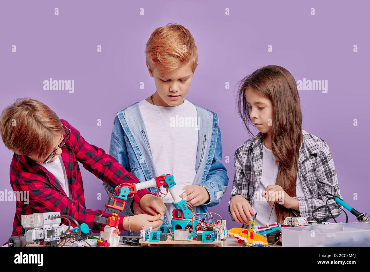 future engineers and designers. caucasian kids try to connect wires and ...