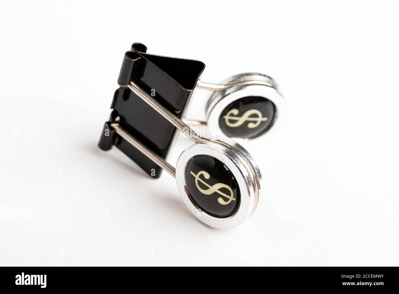 A close-up of a black document clip with a circular press handle ...