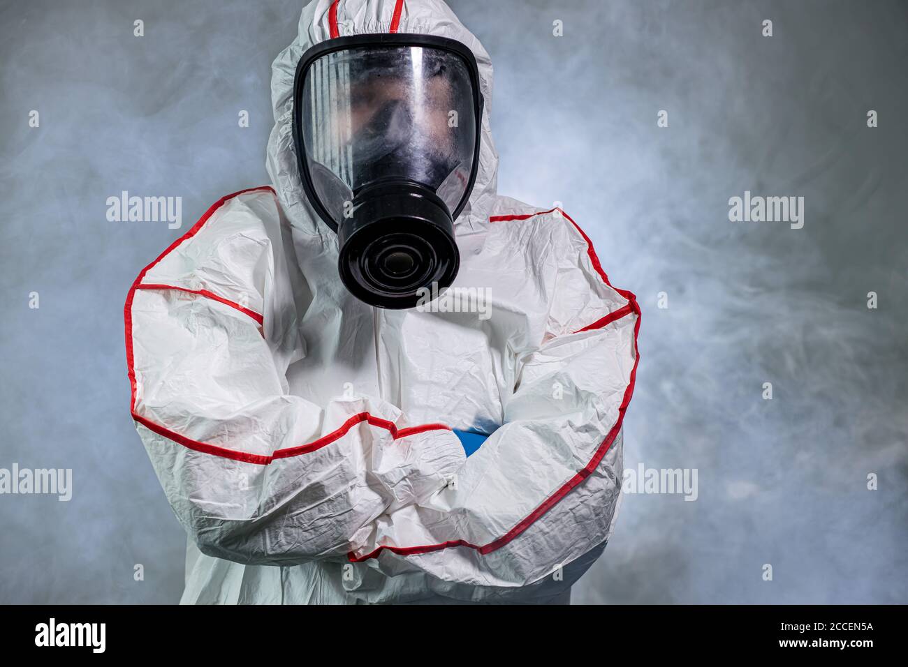 professional disinfector wearing protective biological suit and gas ...