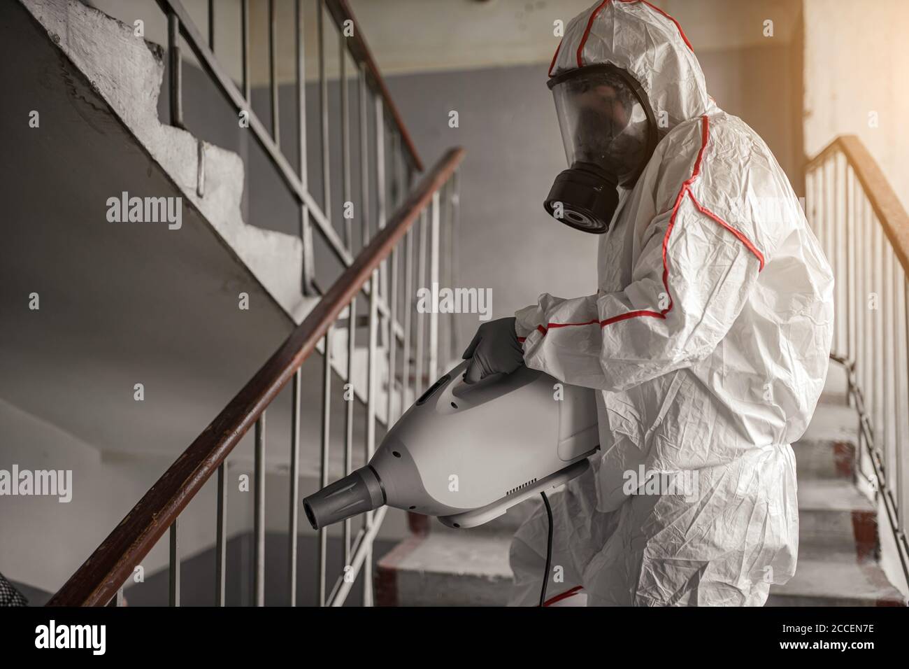virologist in protective hazmat suit conducts disinfections of surfaces ...