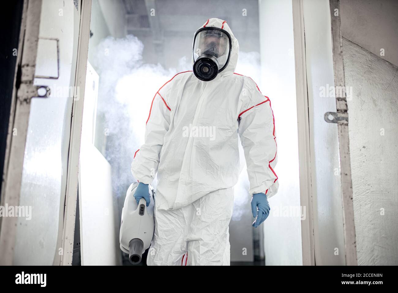 professional disinfector in an NBC personal protective equipment ppe ...