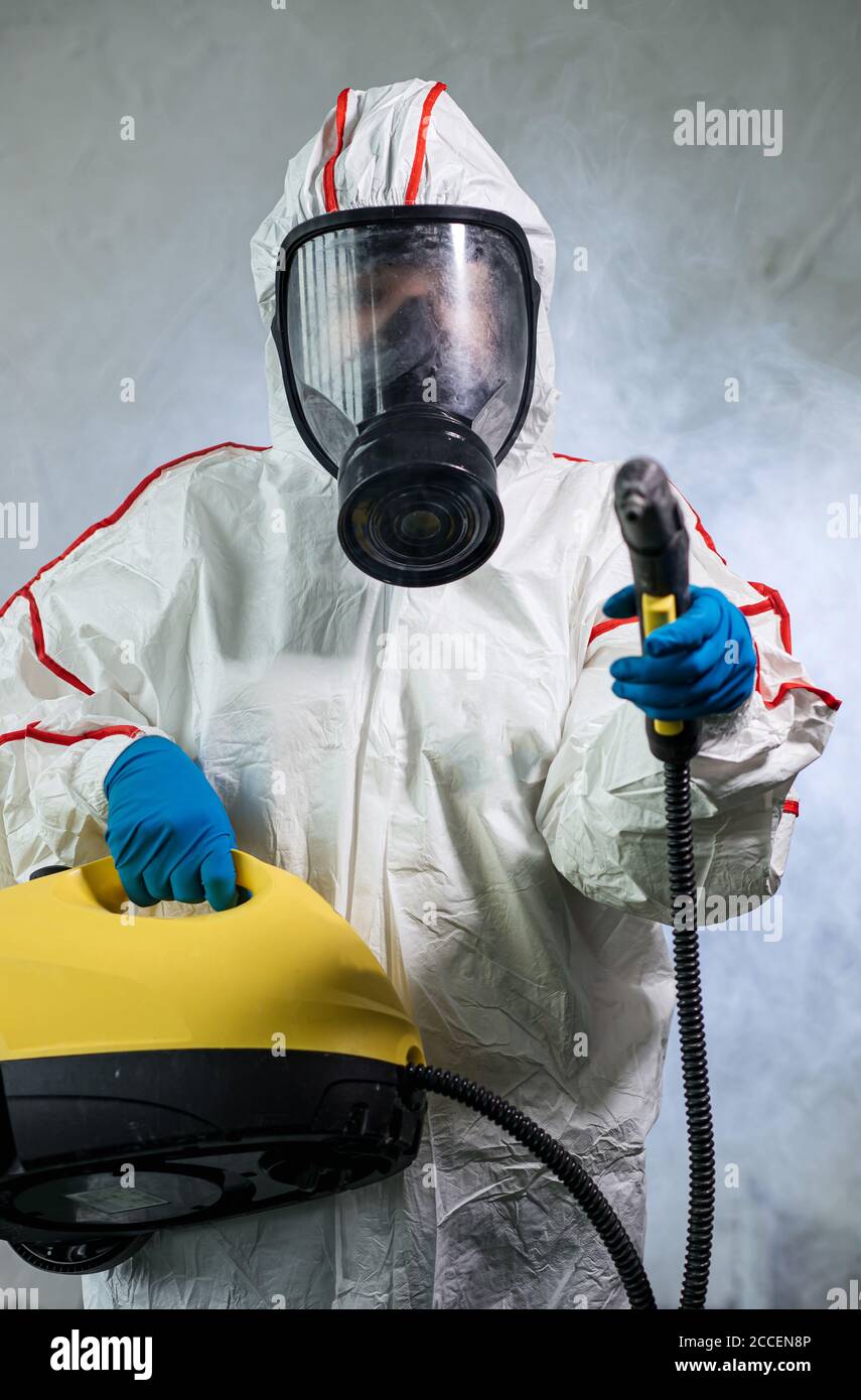 caucasian disinfector use sprayers and germs that adhere on objects on ...