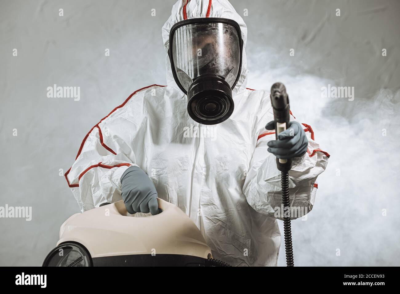 virologist in protective hazmat suit conducts disinfections of surfaces ...