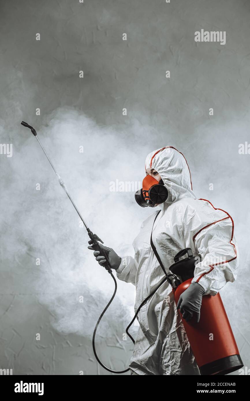 professional disinfector fully armed with necessary equipment, ready to ...