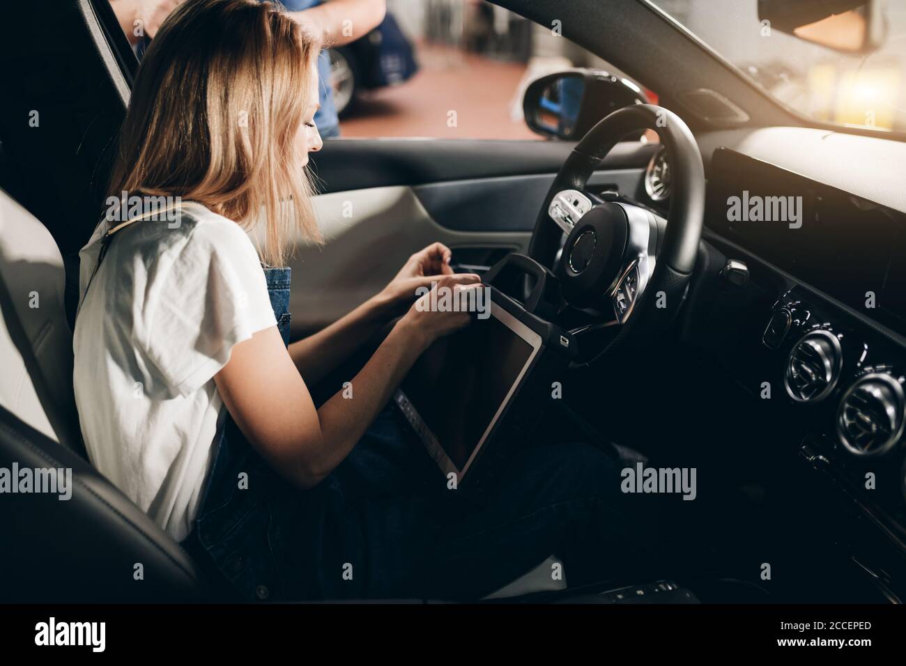 young woman controlling the car. close up side view photo Stock Photo ...