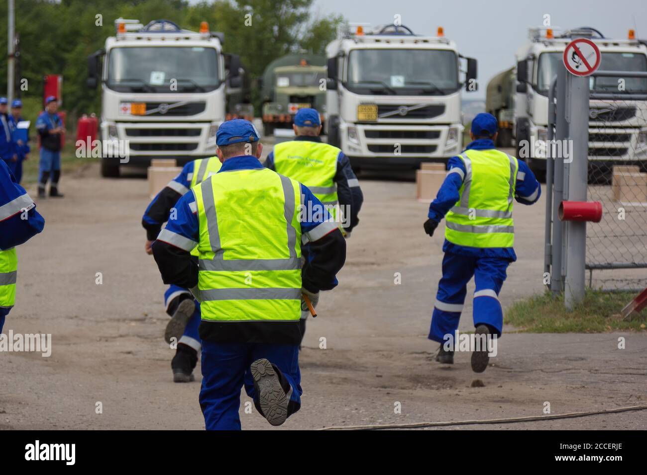Workers in uniform are running in emergency situation Stock Photo - Alamy