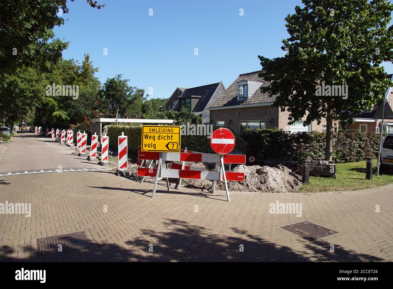 Dutch roadwork with traffic signs in a street. Message sign with the ...