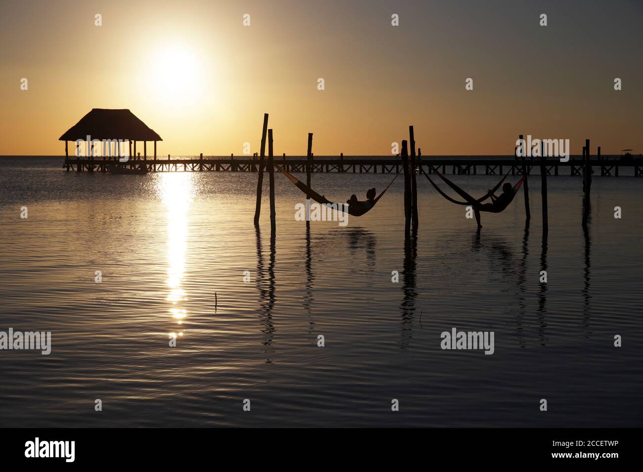 Tourists sunbathing on a beach of Holbox next to some hammocks Stock ...