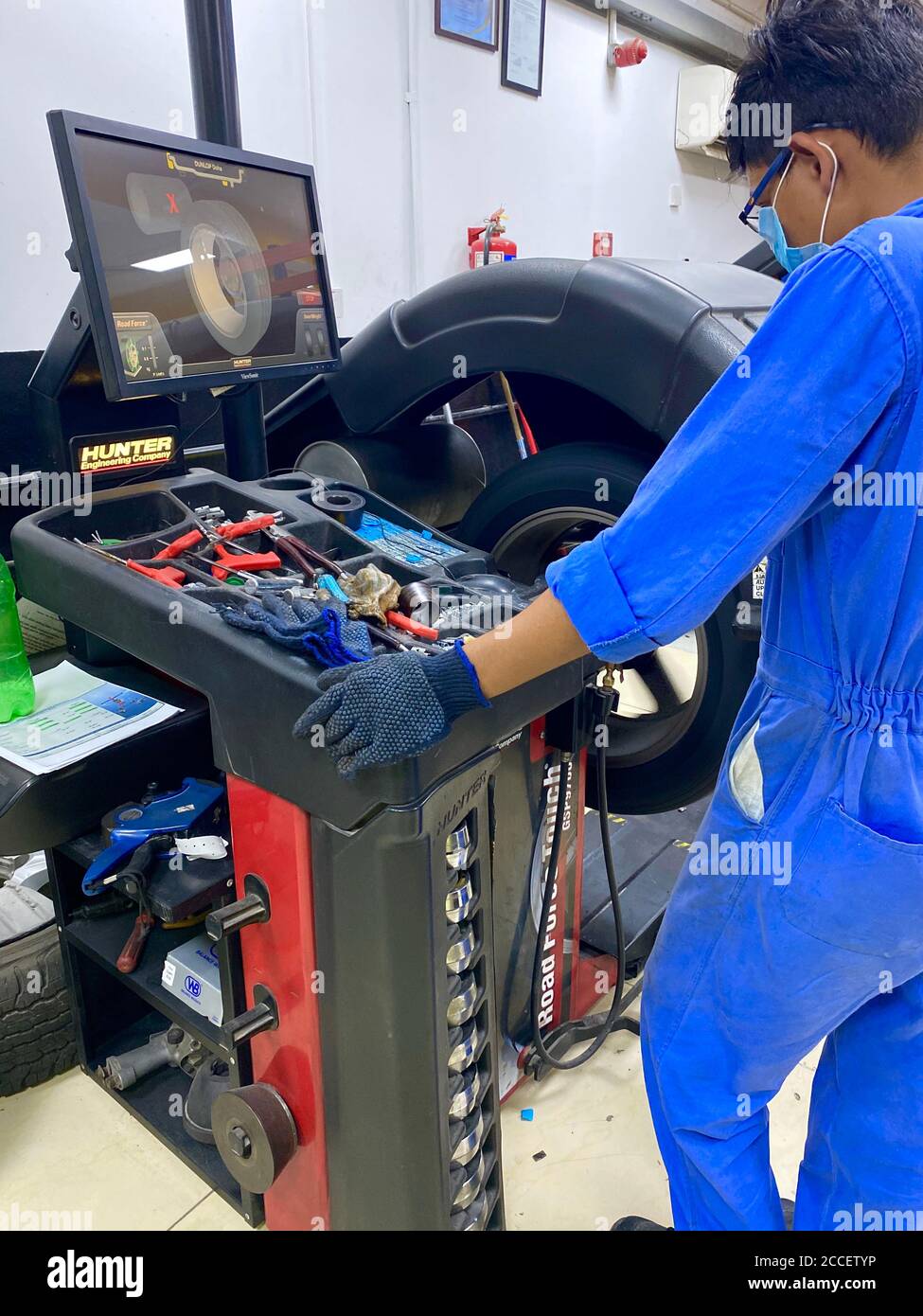 Mechanic balancing wheel with machine balancer at service Stock Photo ...