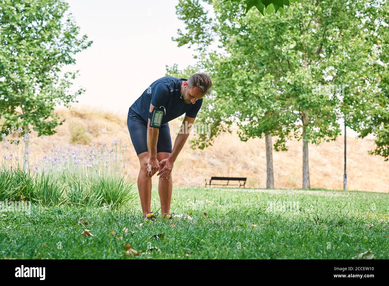 Man Rests After Exercise He Rests His Hands On His Knees Concept Of Healthy Life And Sport