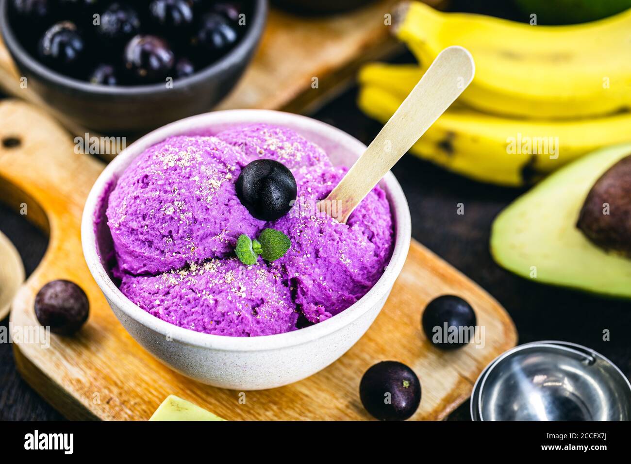 exotic jabuticaba ice cream, purple color. Dessert served in ...