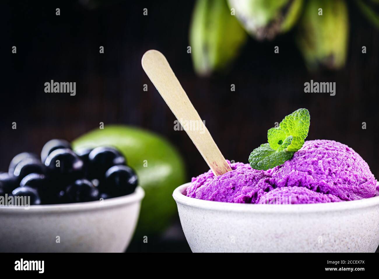 exotic jabuticaba ice cream, purple color. Dessert served in ...