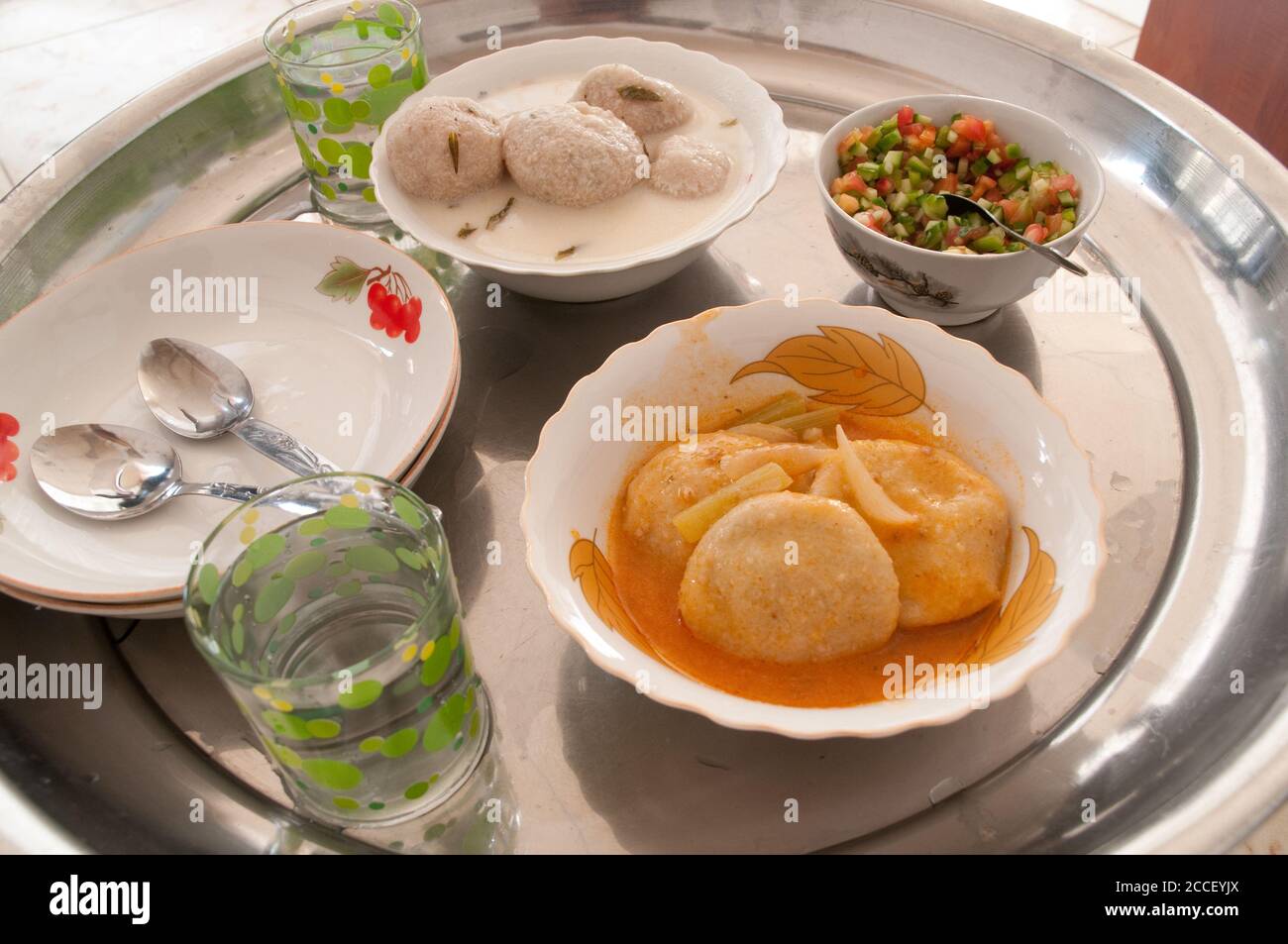 A light Kurdish lunch of semolina bulgur kibbe and a salad, served on a ...