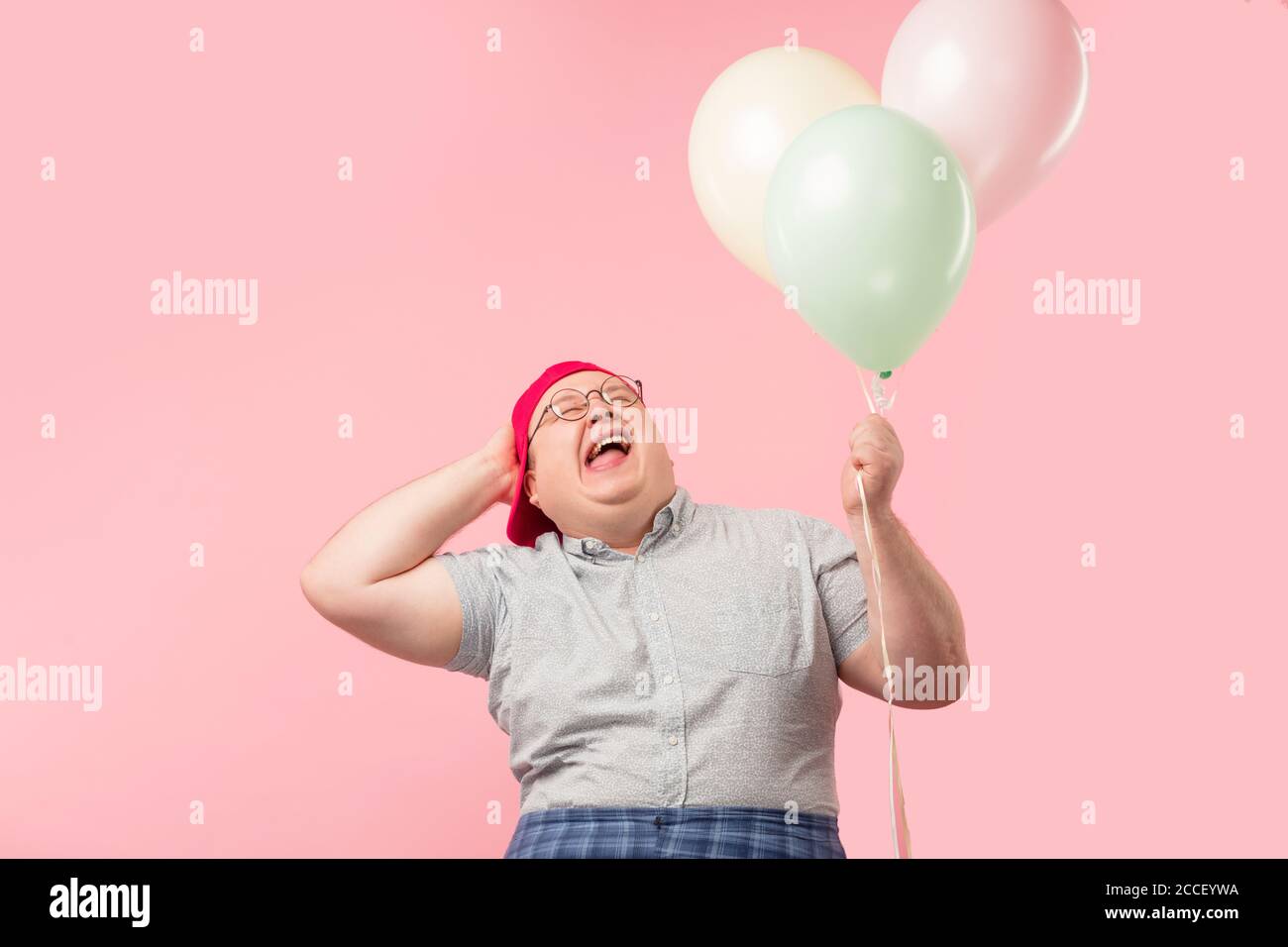 Middle aged happy father dressed in childish style looking at camera ...