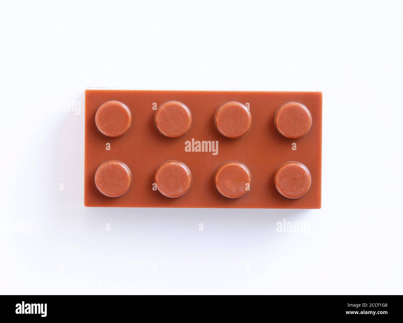 Brown plastic building block on white background Stock Photo - Alamy
