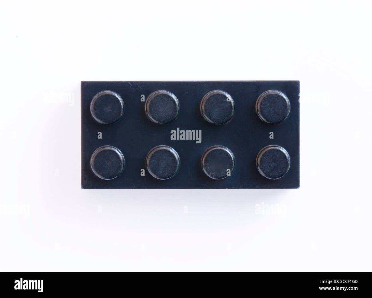 Black plastic building block on white background Stock Photo - Alamy