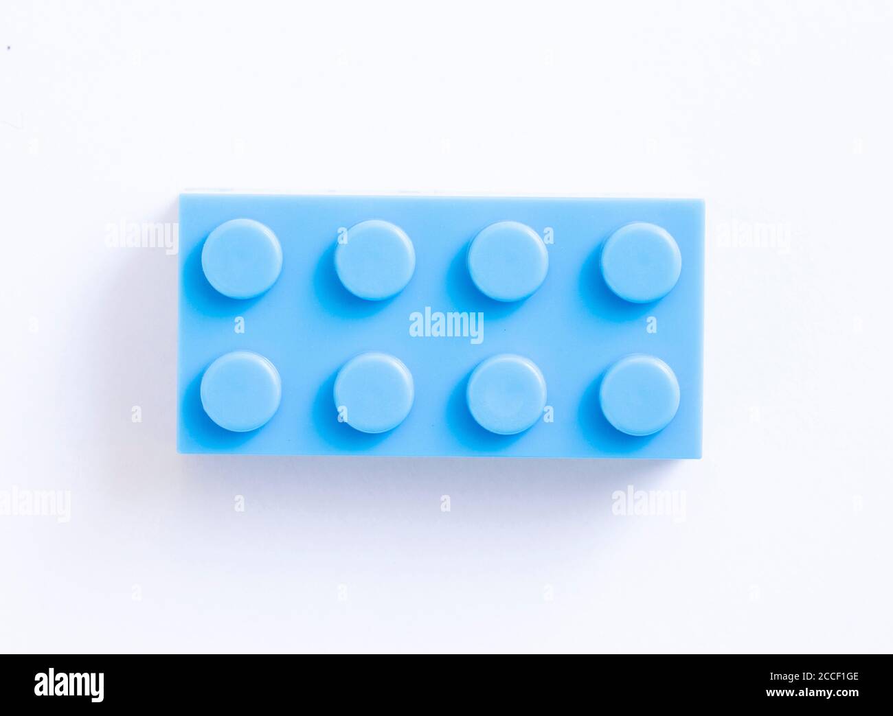 Blue plastic building block on white background Stock Photo - Alamy