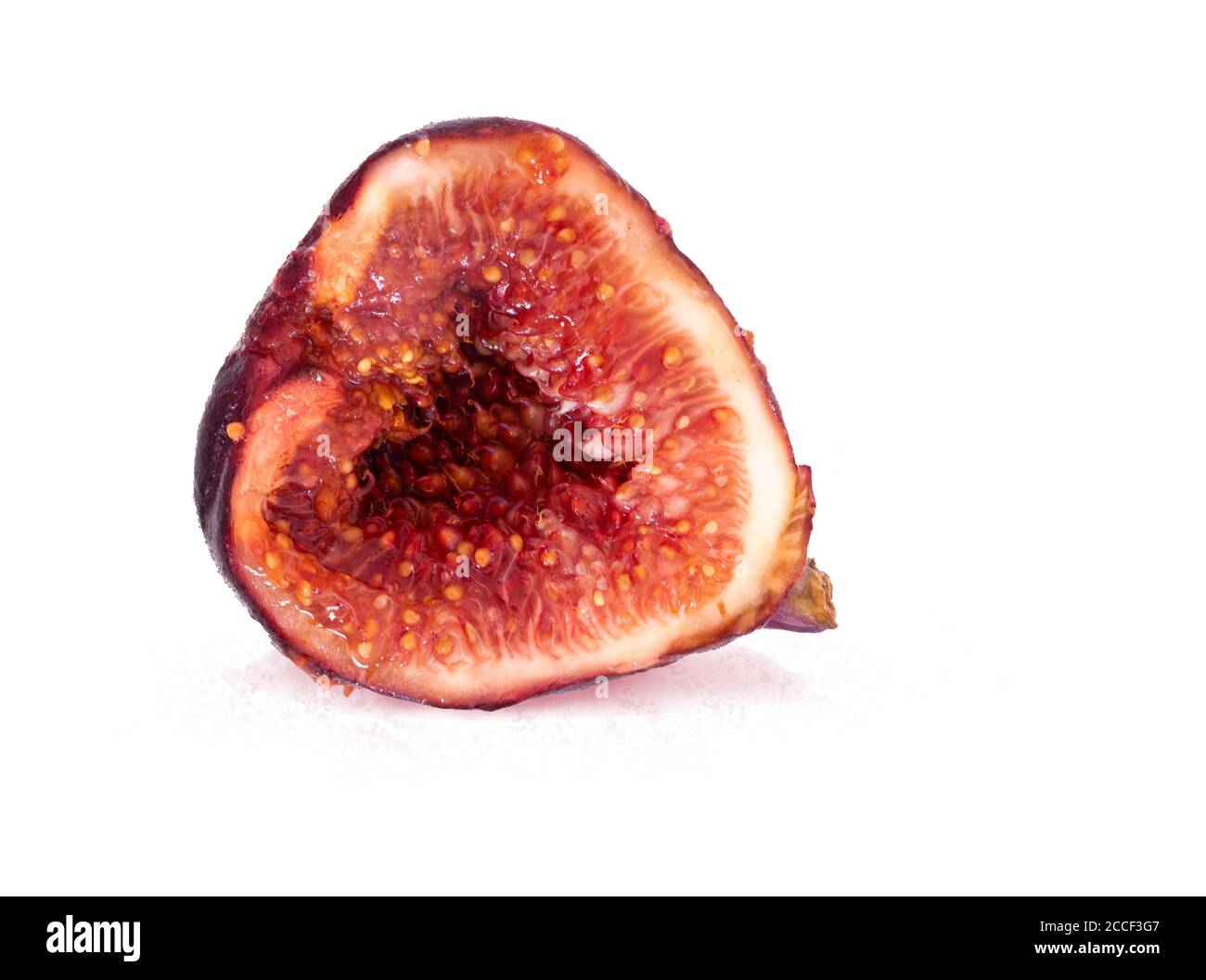 Closeup of a fig cut in half and showing the detail of the juicy red ...