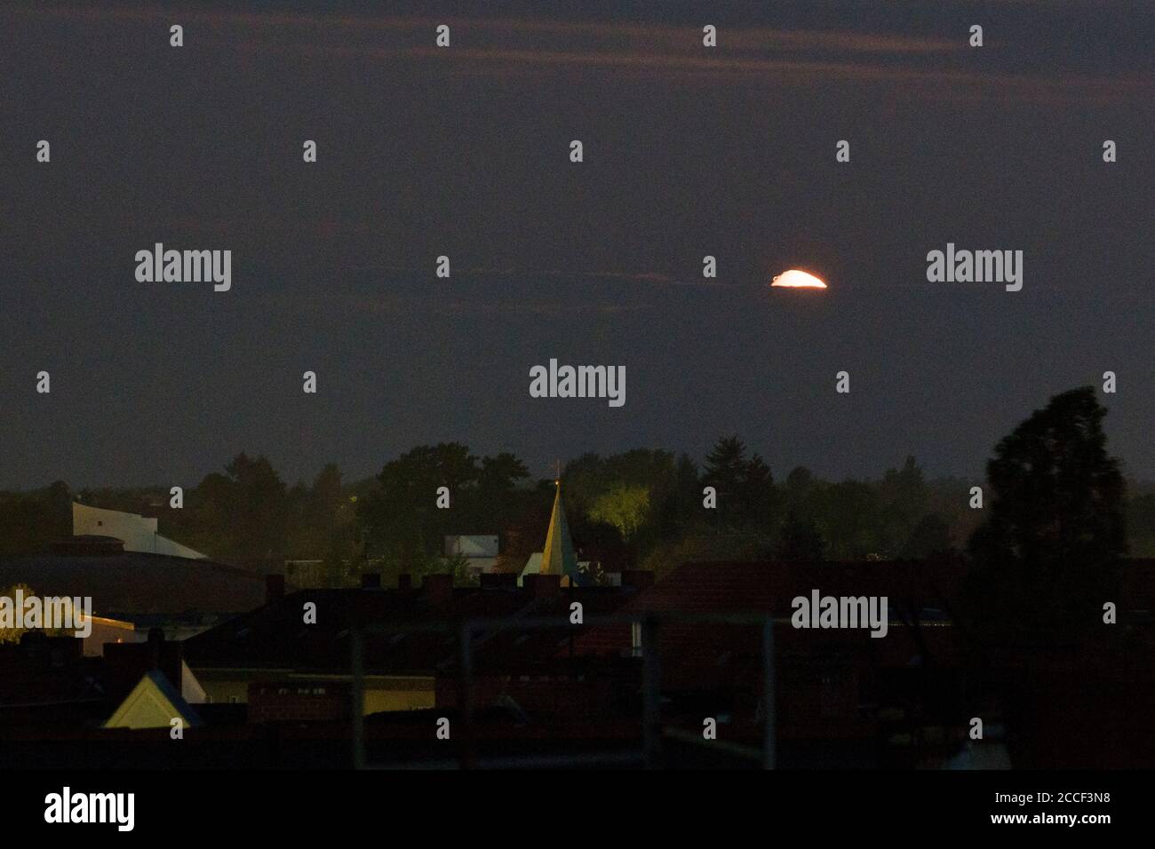 Setting moon with a golden handle, Berlin, looking west, dawn Stock ...