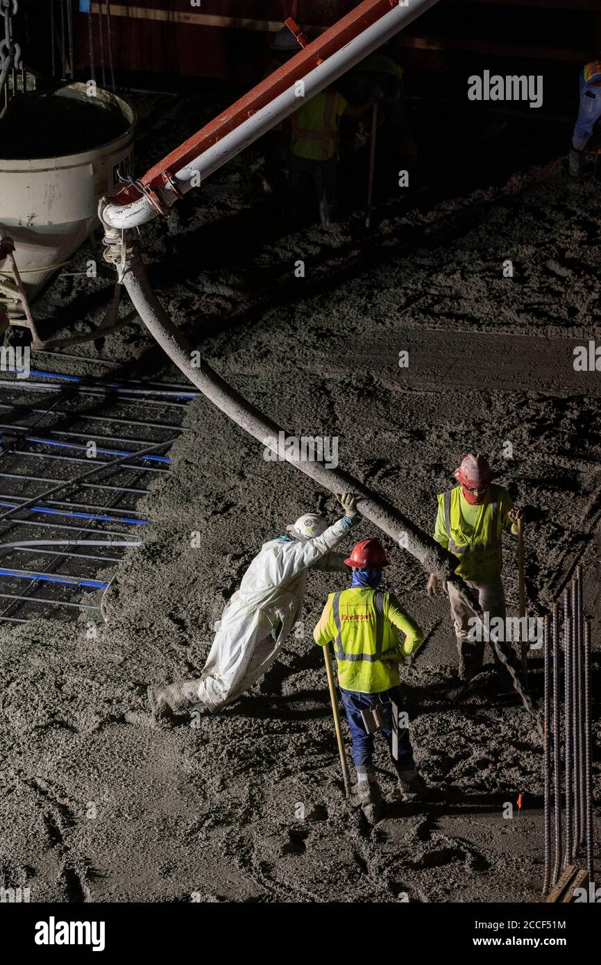 Austin, Texas, USA. 25th July, 2020. Concrete crews work on the parking ...