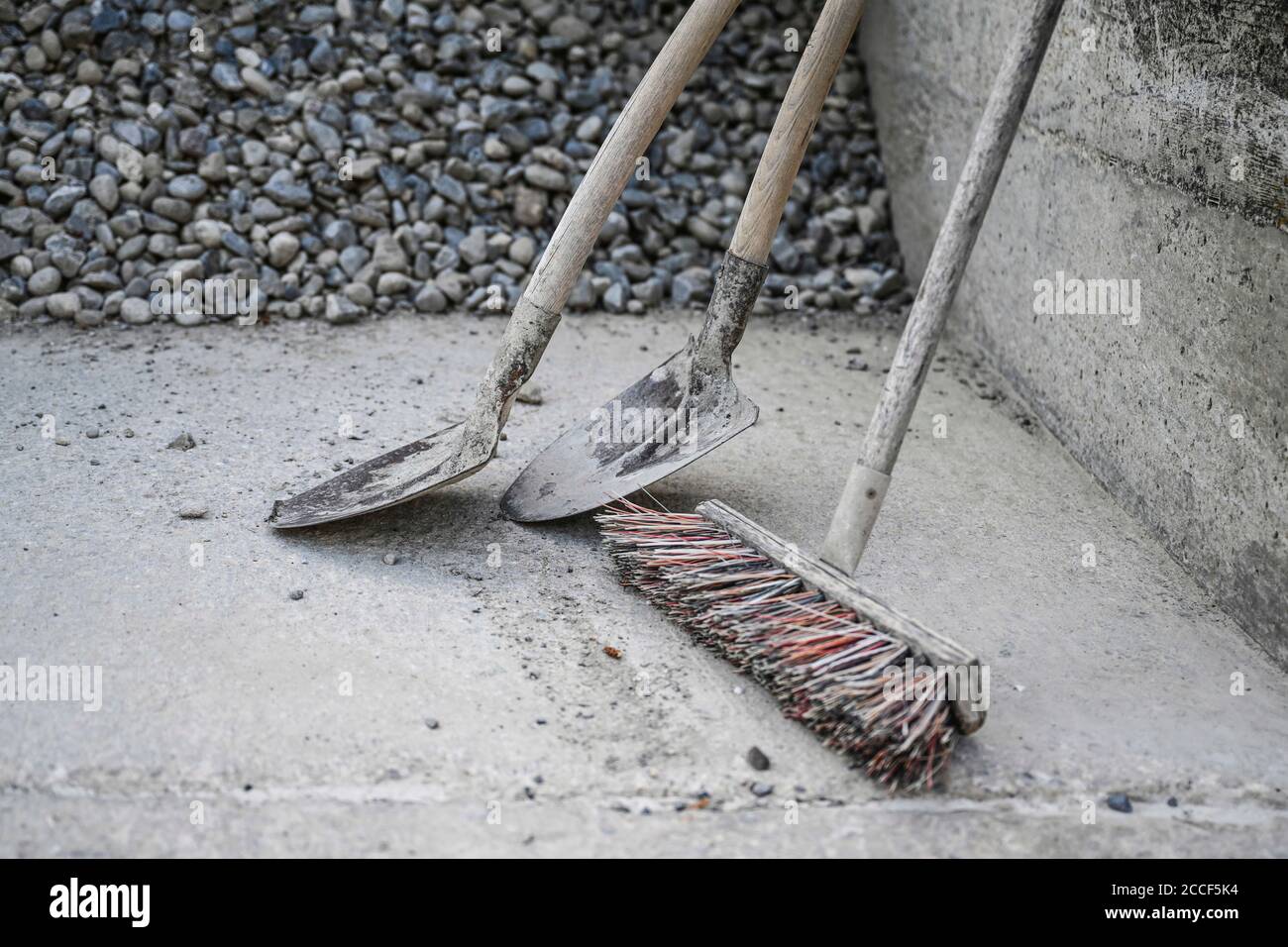 Shovel and bristle broom Stock Photo - Alamy