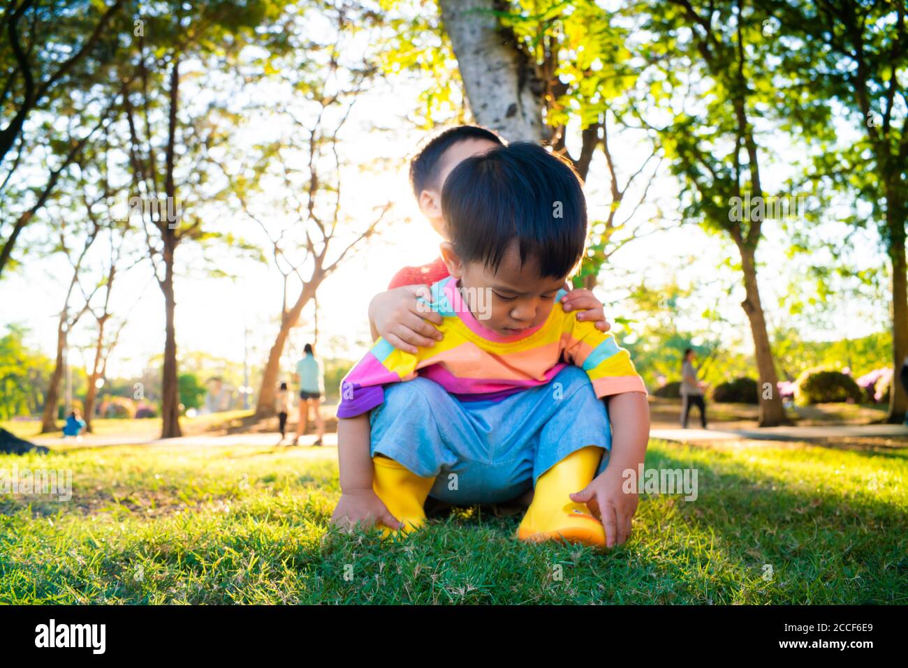 Group of happy children playing on green grass activity sunset light ...