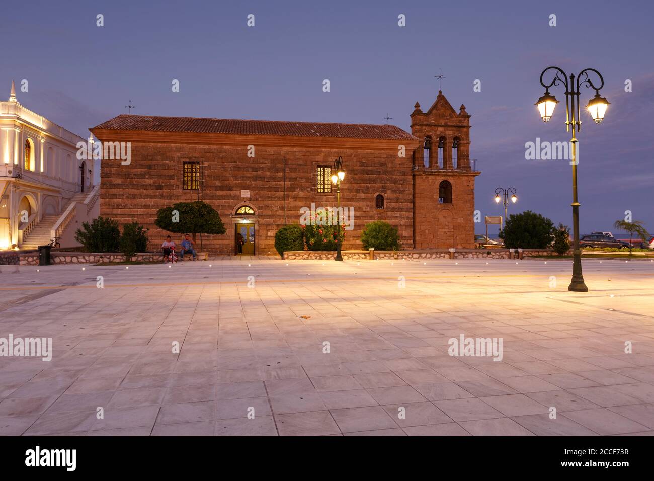 People sitting in front of St Nikolaos Molou church in Solomos square ...