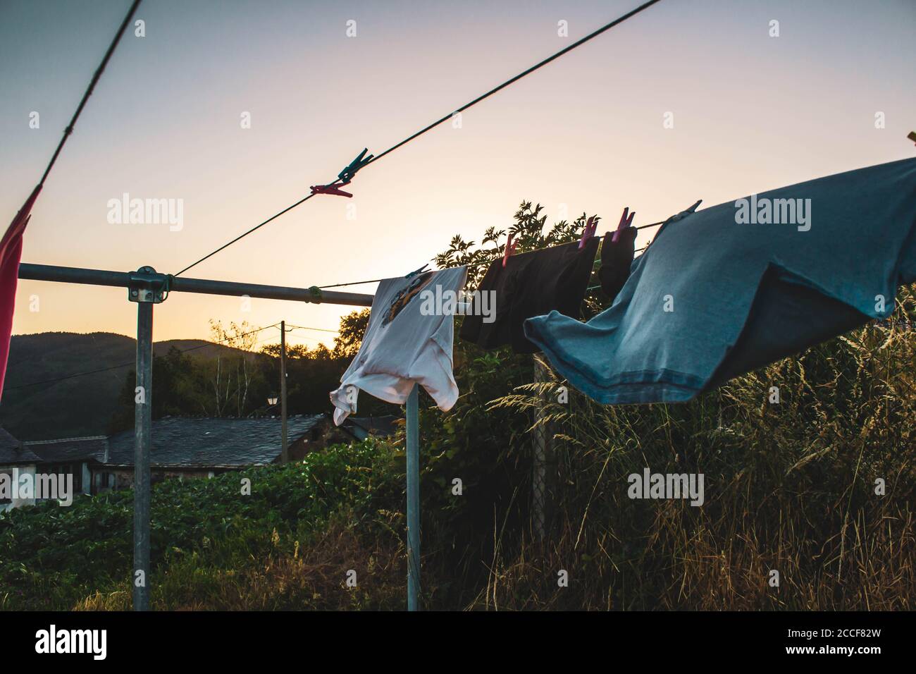 clothes hanging on the outdoor clothesline with sunset behind Stock ...