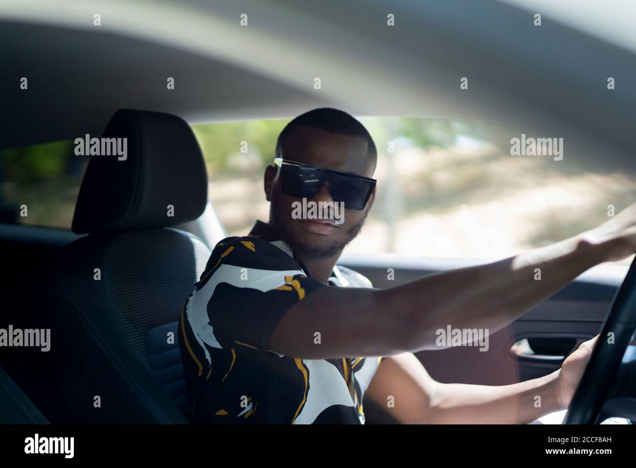 young african man driving his white car Stock Photo - Alamy