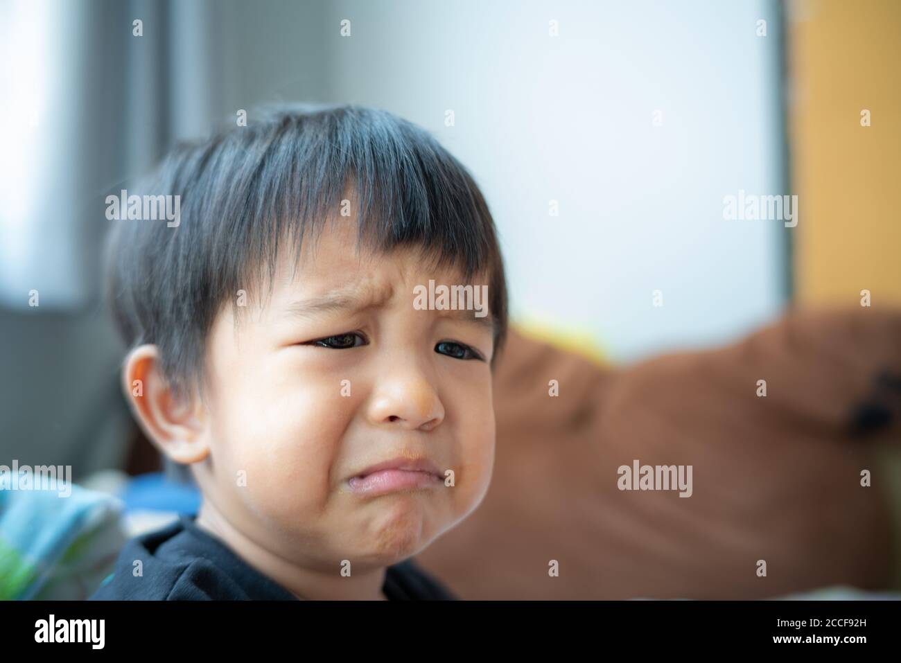 Little asian boy crying bitterly in room of house facial face mood ...